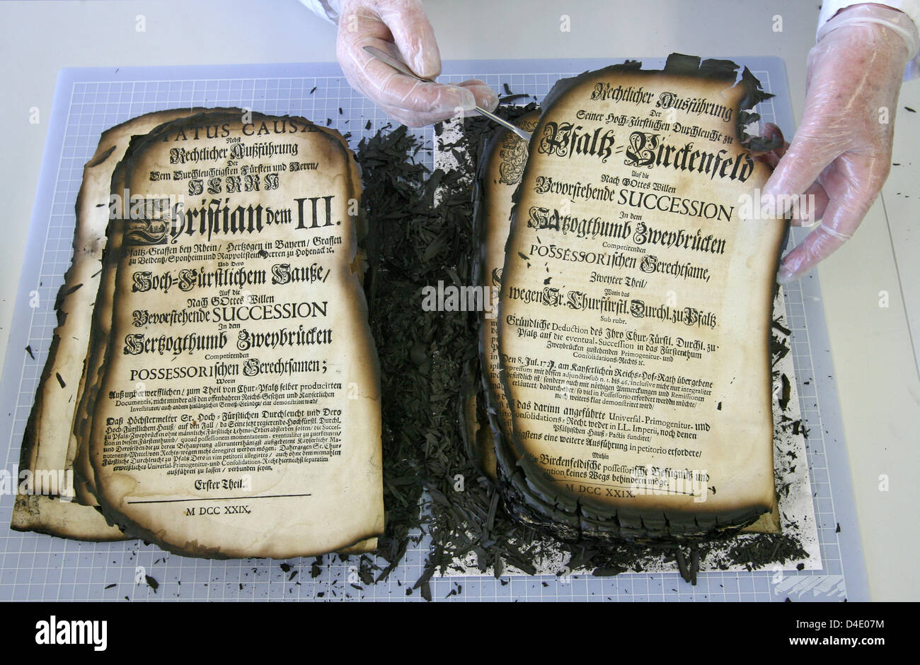 Book pages are carefully seperated in the restorage workshop for ...