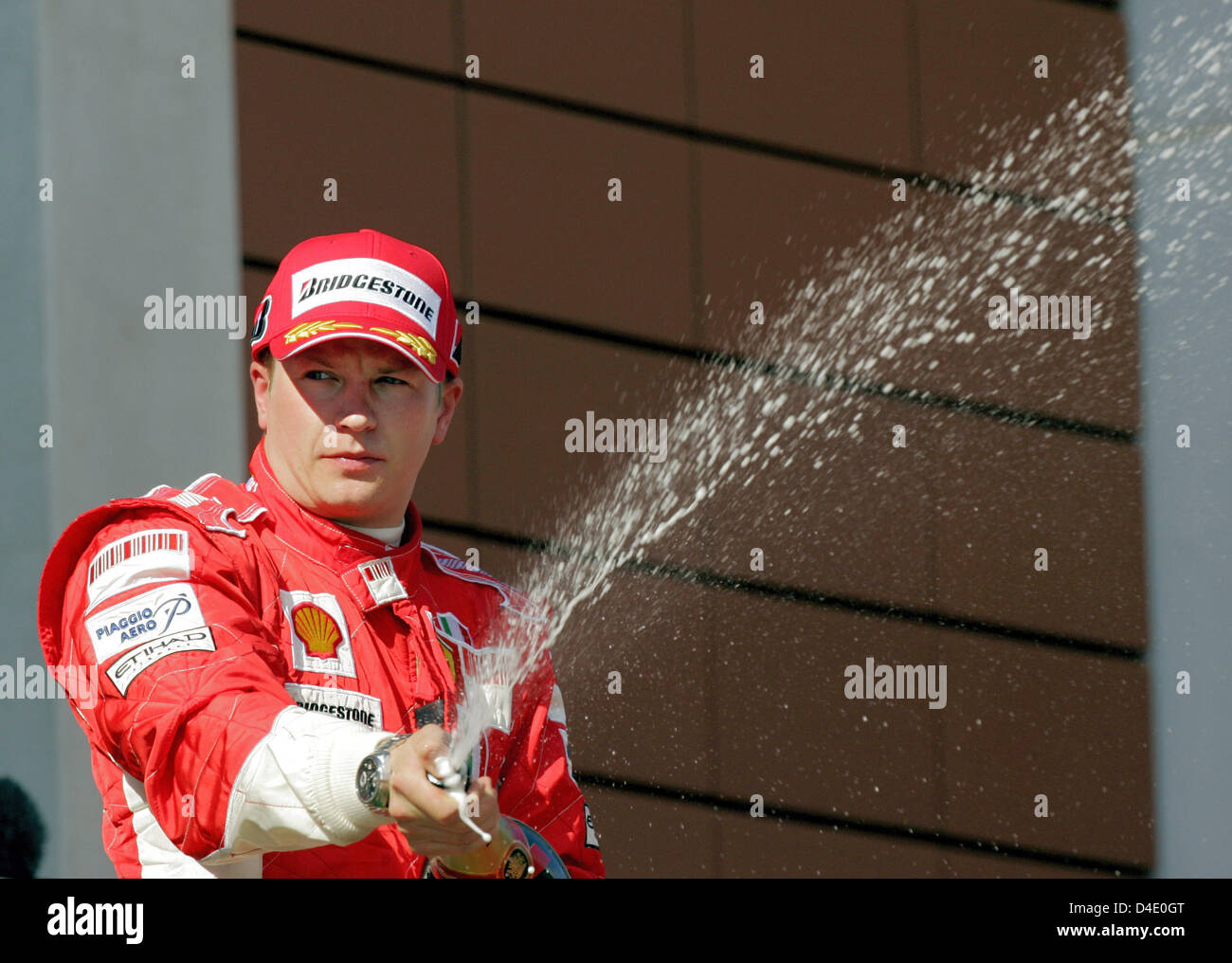 Finnish Formula One driver Kimi Raikkonen of Scuderia Ferrari sprays ...