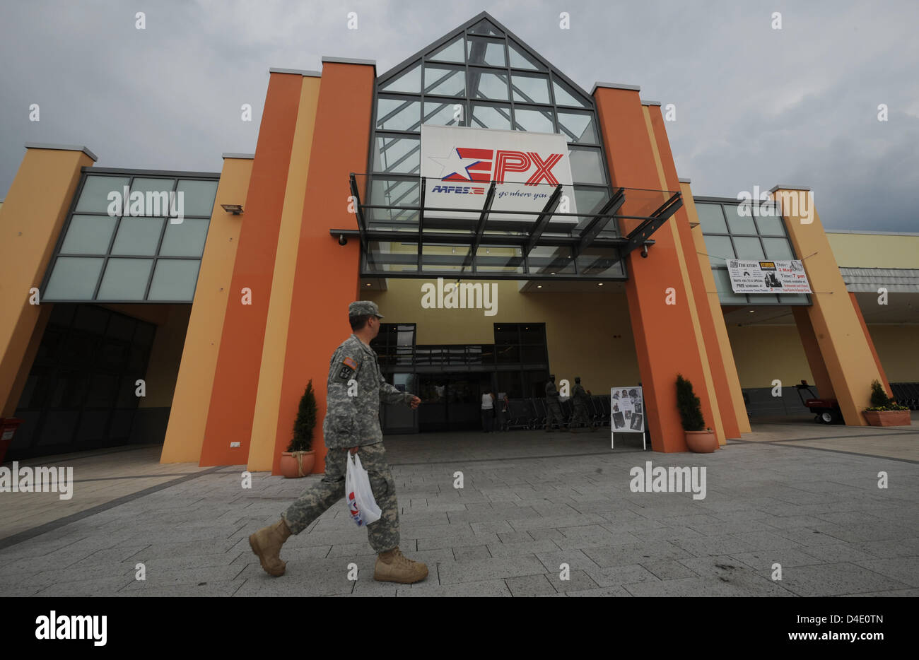 A G.I. walks past the PX of US Army training area Grafenwoehr, Germany ...