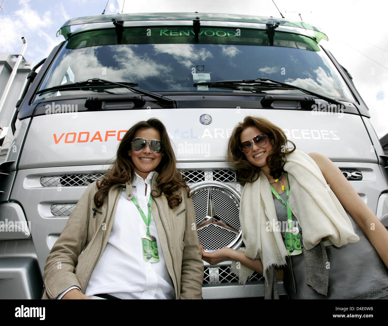 Female Formula One fans pose front of a McLaren Mercedes team truck at ...
