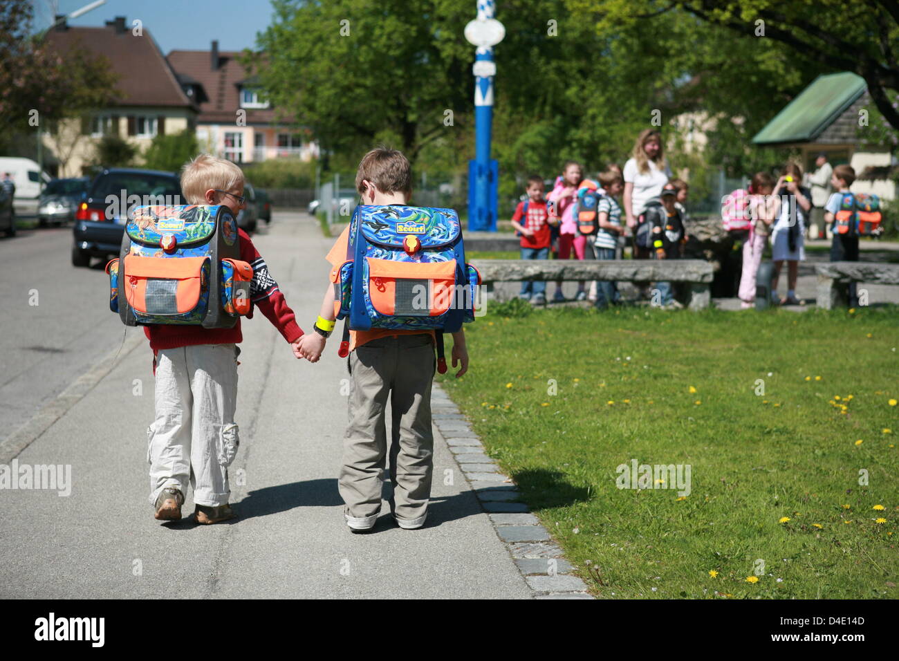 Two boys with knapsacks on their backs are on their way to school in ...