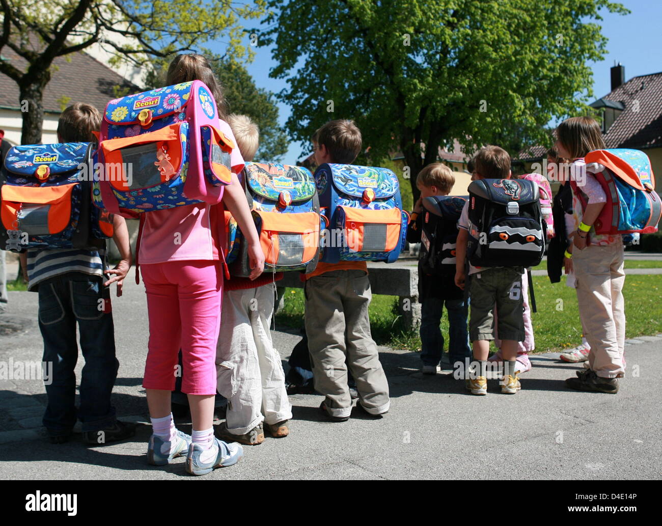 A group of pupils with knapsacks on their backs is on their way to ...