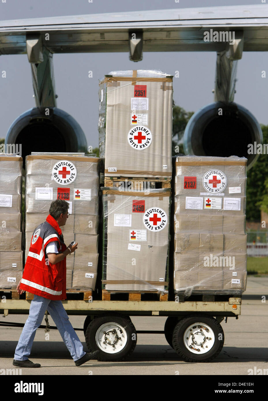 Boxes with the logo of the German Red Cross (DRK) are pictured in front ...