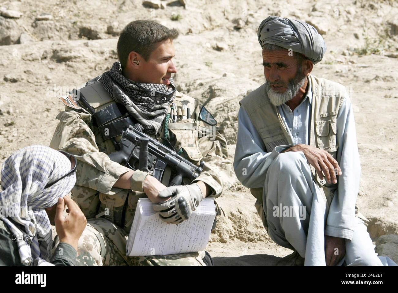 A German Bundeswehr soldier and an Afghan ANA soldier rest near ...