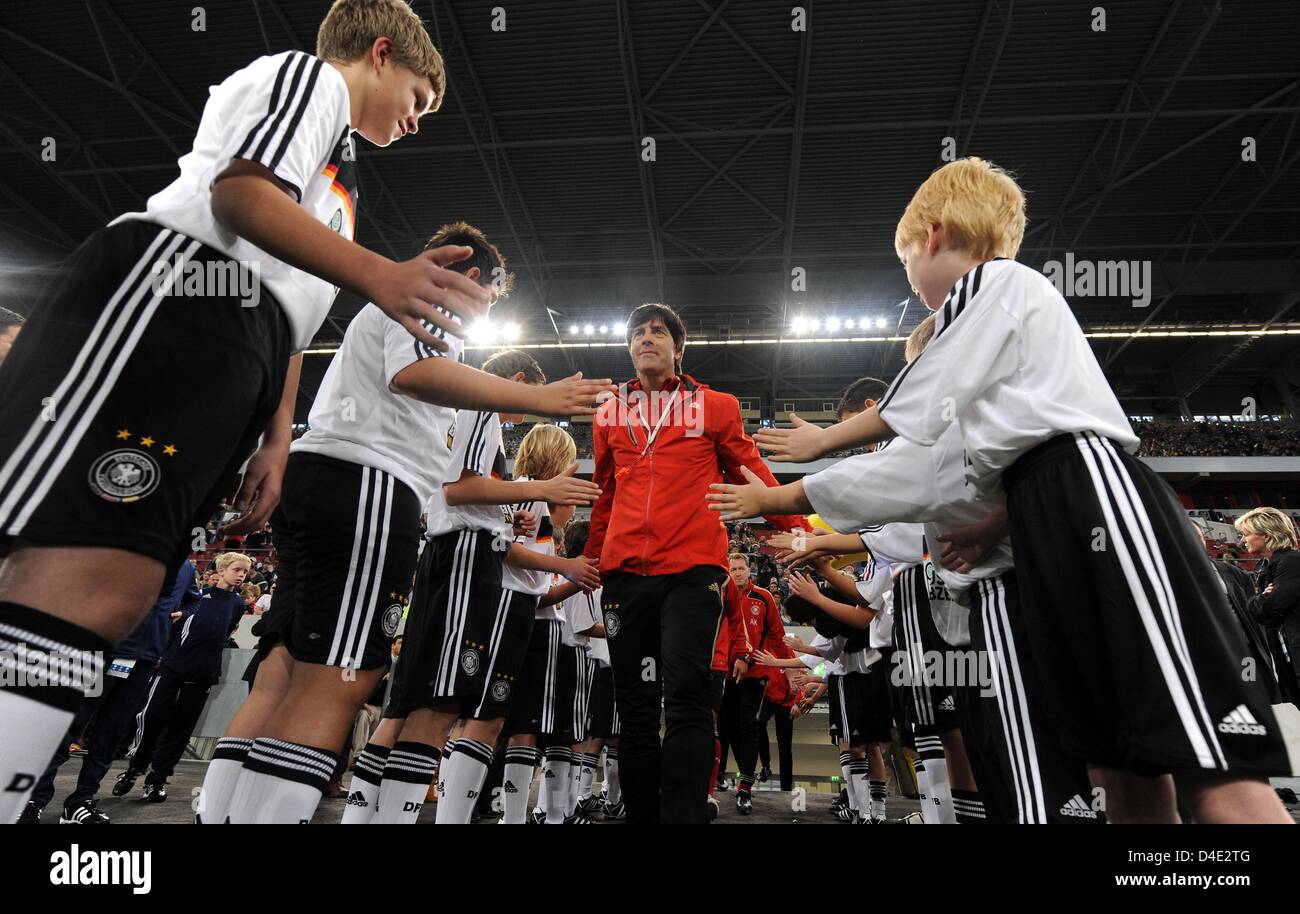German national coach Joachim Loew (C) walks through a guard of honour ...