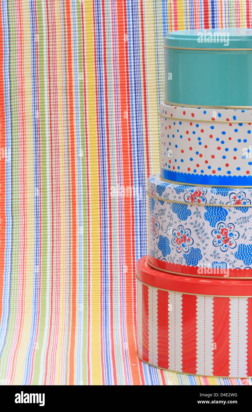 A stack of tin cans against a colorful background Stock Photo - Alamy
