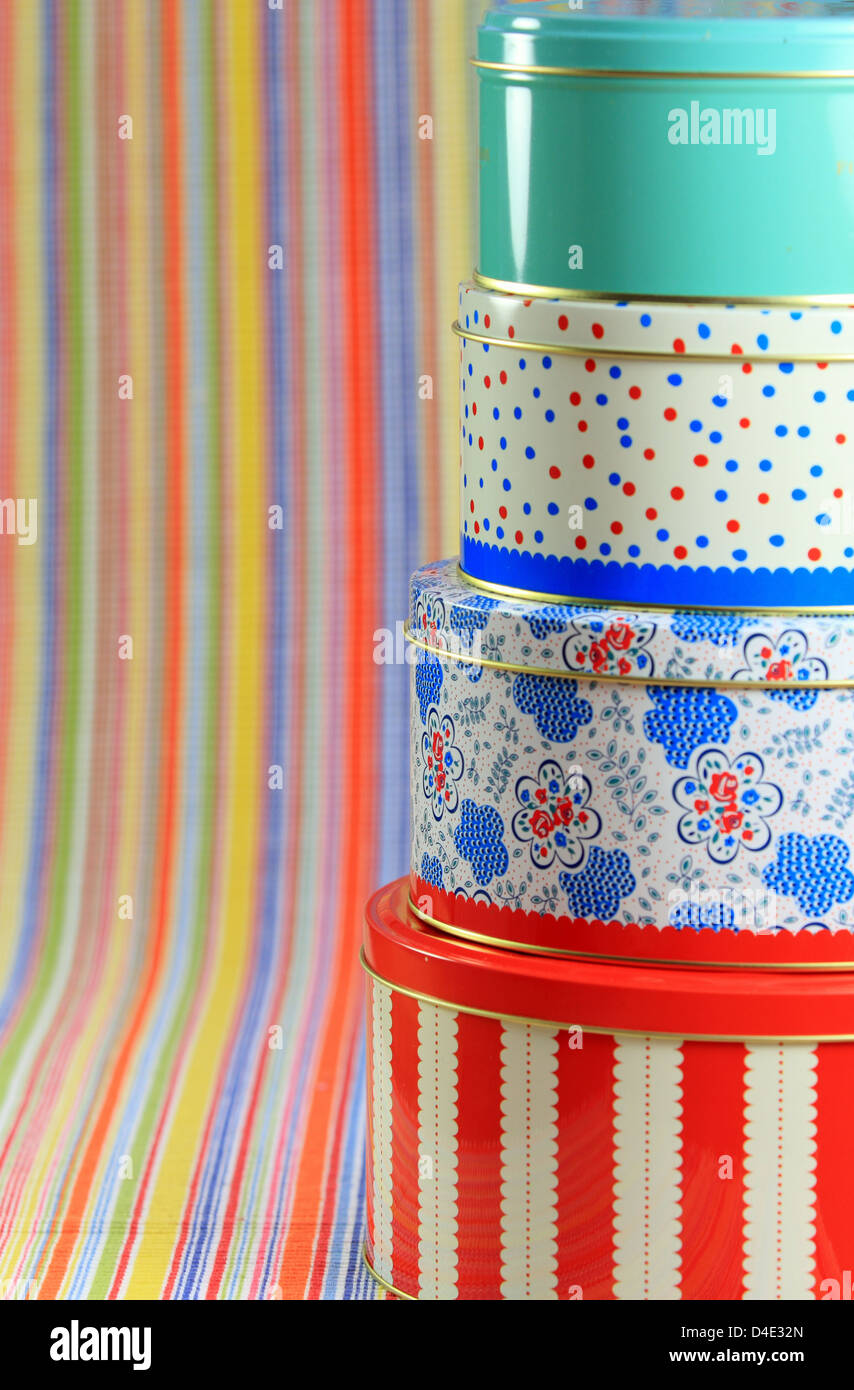 A stack of tin cans against a colorful background Stock Photo - Alamy