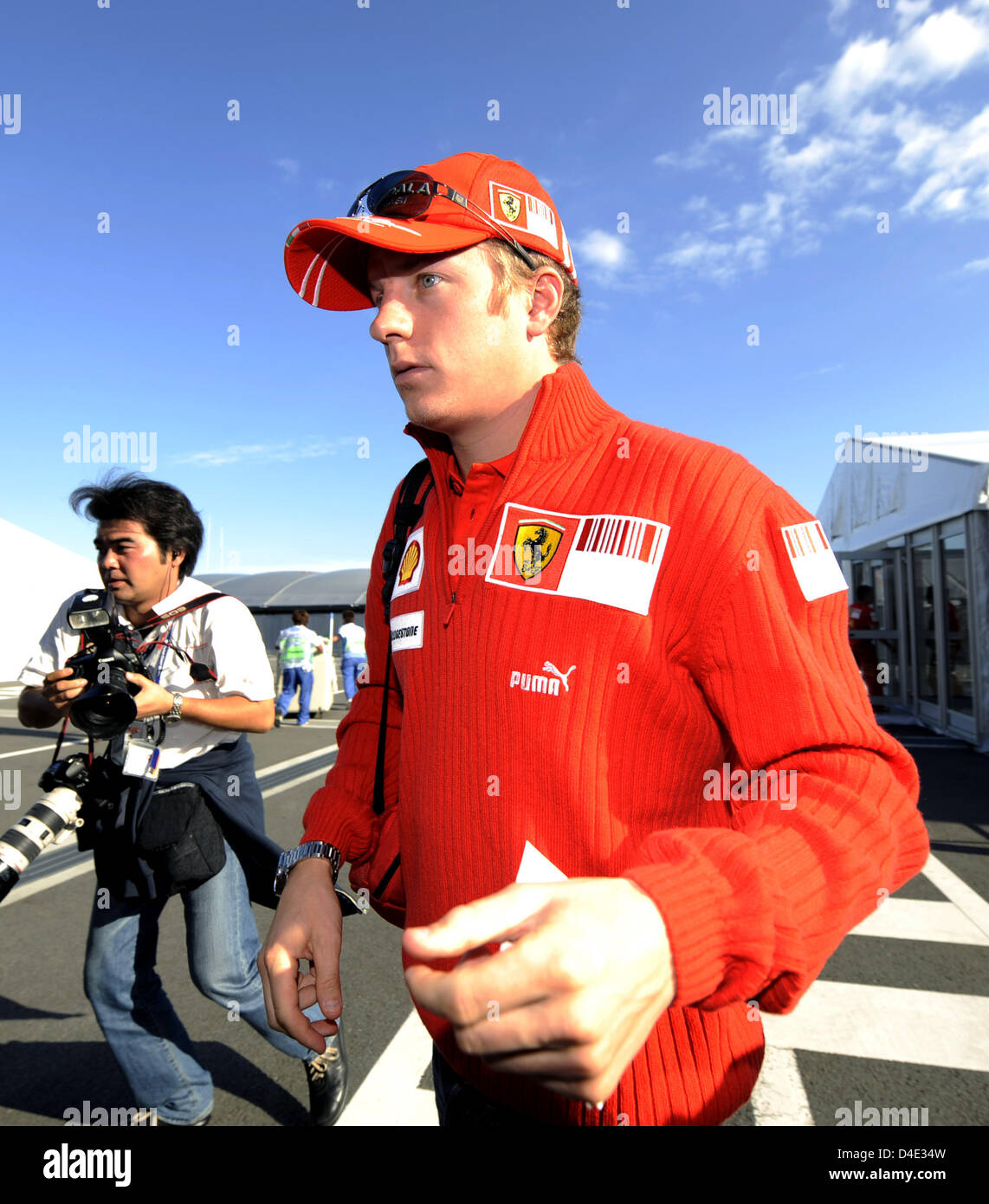 Finnish Formula One driver Kimi Raikkonen of Ferrari (R) arrives at ...