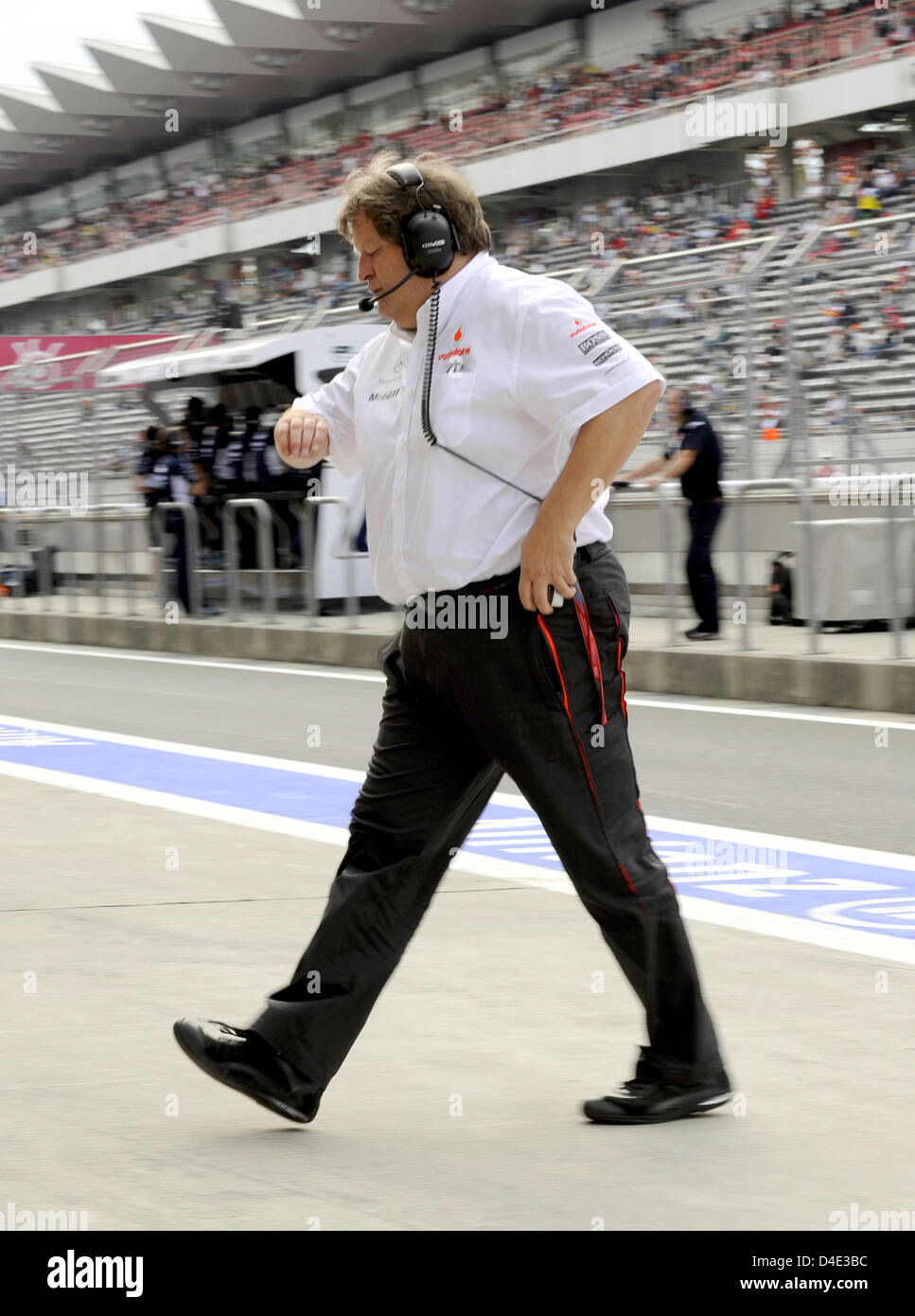 Mercedes Motorsport Director, German Norbert Haug, walks across the pit ...