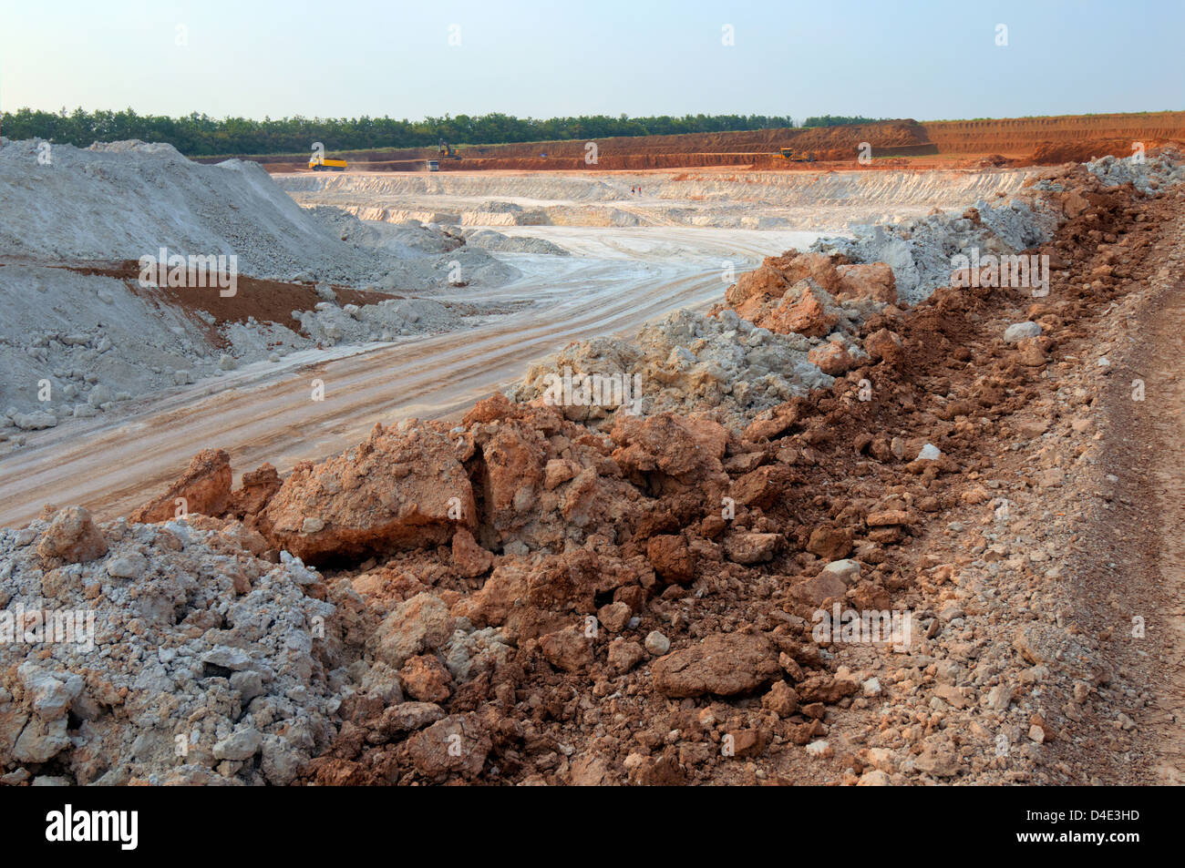 A Construction vehicle loading clay onto a cargo truck Stock Photo - Alamy