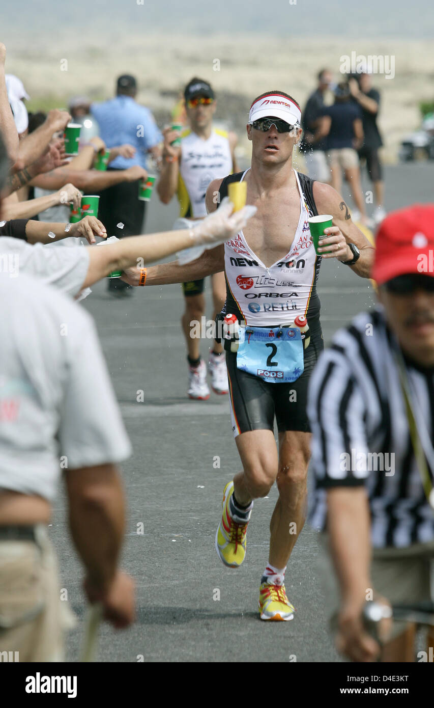 Australian Craig Alexander (C) is pictured as he wins the Ironman ...
