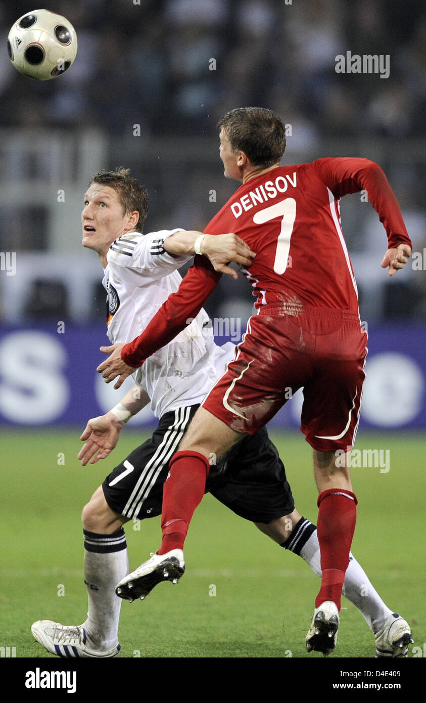 Russia's Igor Denisov (R) tackles Germany's Bastian Schweinsteiger (L) in the FIFA World Cup ...