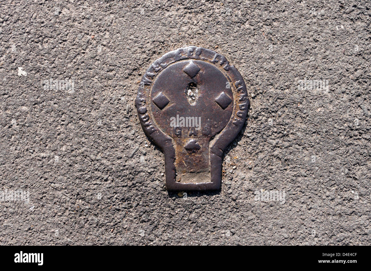 Gas tap inspection cover in street Stock Photo - Alamy