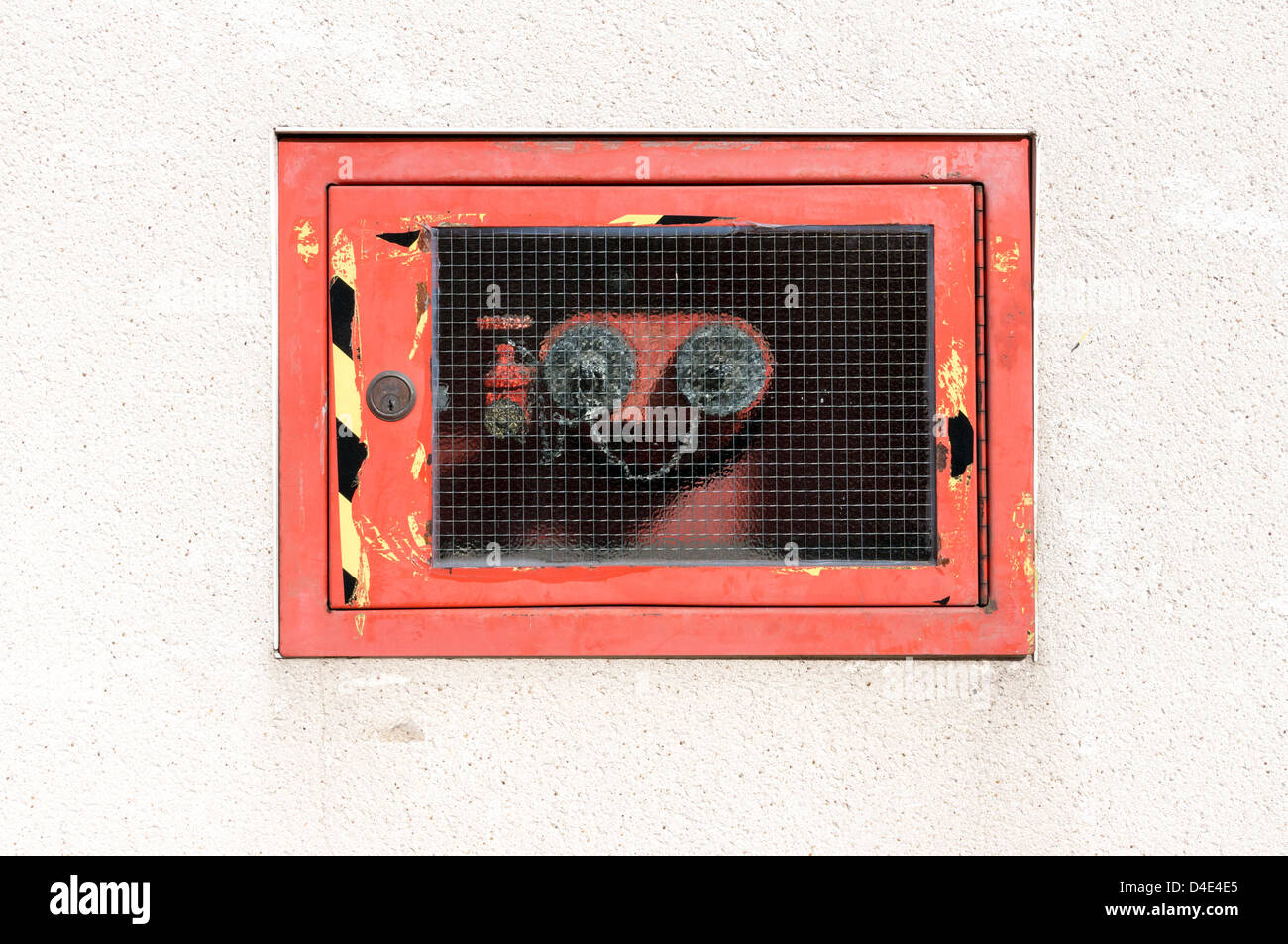 Fire hydrant set into a wall behind toughened obscured glass Stock ...