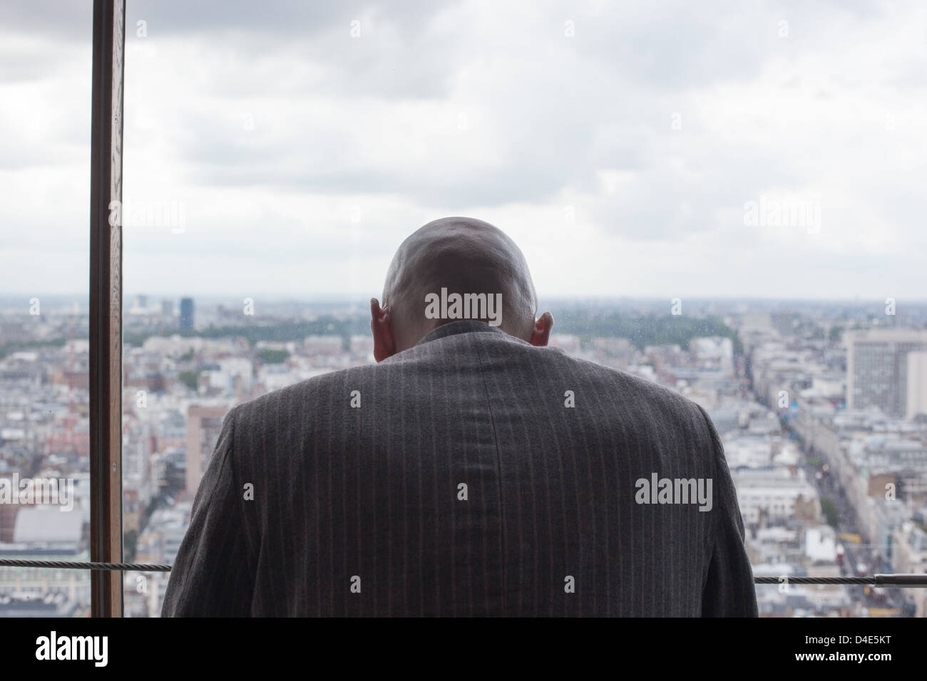 A bald man overlooking the city Stock Photo - Alamy