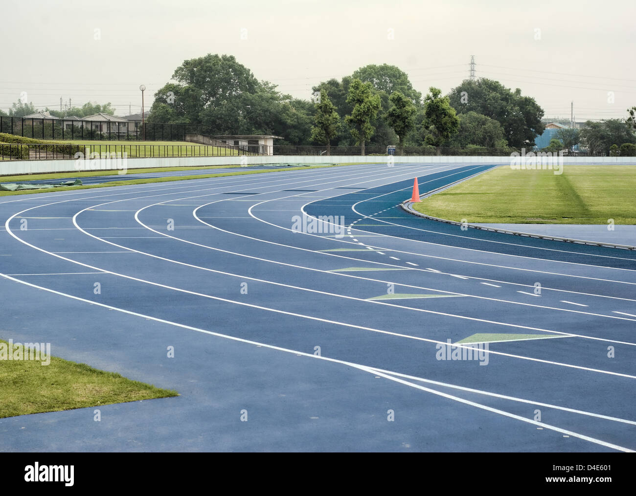 blue racing tracks and grass field Stock Photo - Alamy