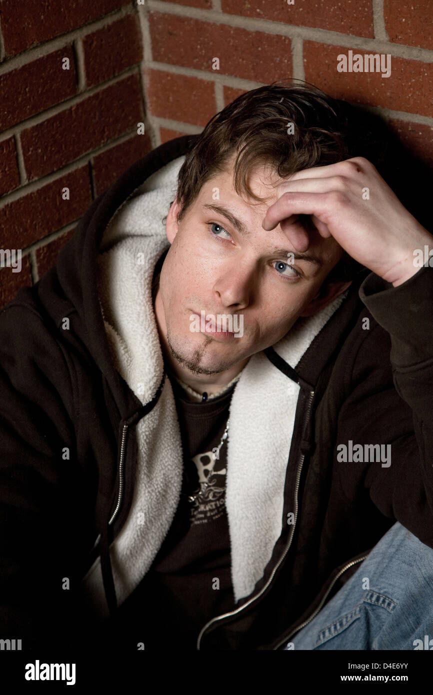 Young troubled looking man wearing a hoodie and in a stairwell Stock ...