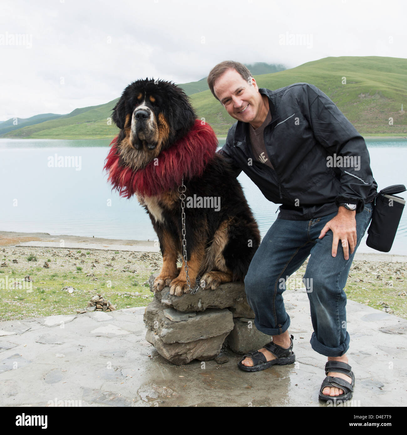 Man posing with Saint Bernard dog on shore of Sacred Lake; Shannan ...