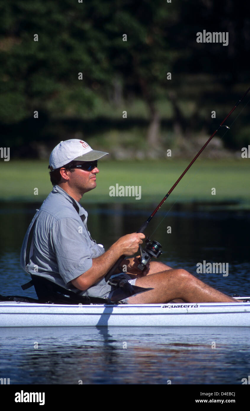 Man fishing for bass from a kayak on a private farm pond Stock Photo ...