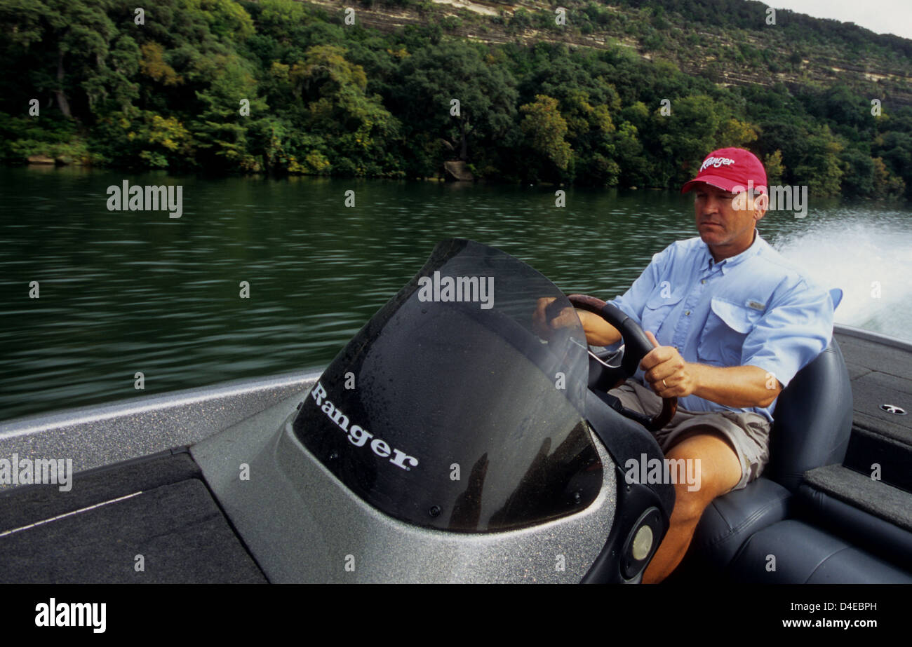 Bass fisherman driving his boat on Lake Austin Texas Stock Photo - Alamy