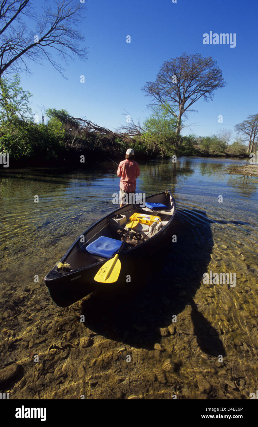 Man fishing for bass from a canoe on the Blanco River Texas Stock Photo ...