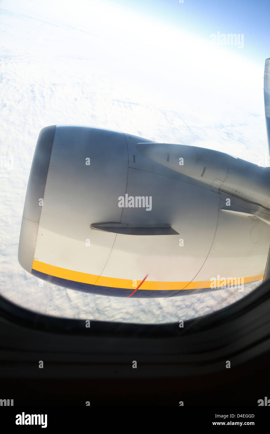 Airplane in the blue sky engine and wings white clouds Stock Photo - Alamy