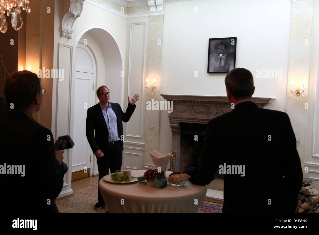 The Curator of an Art Exhibit Explains a Piece Stock Photo - Alamy