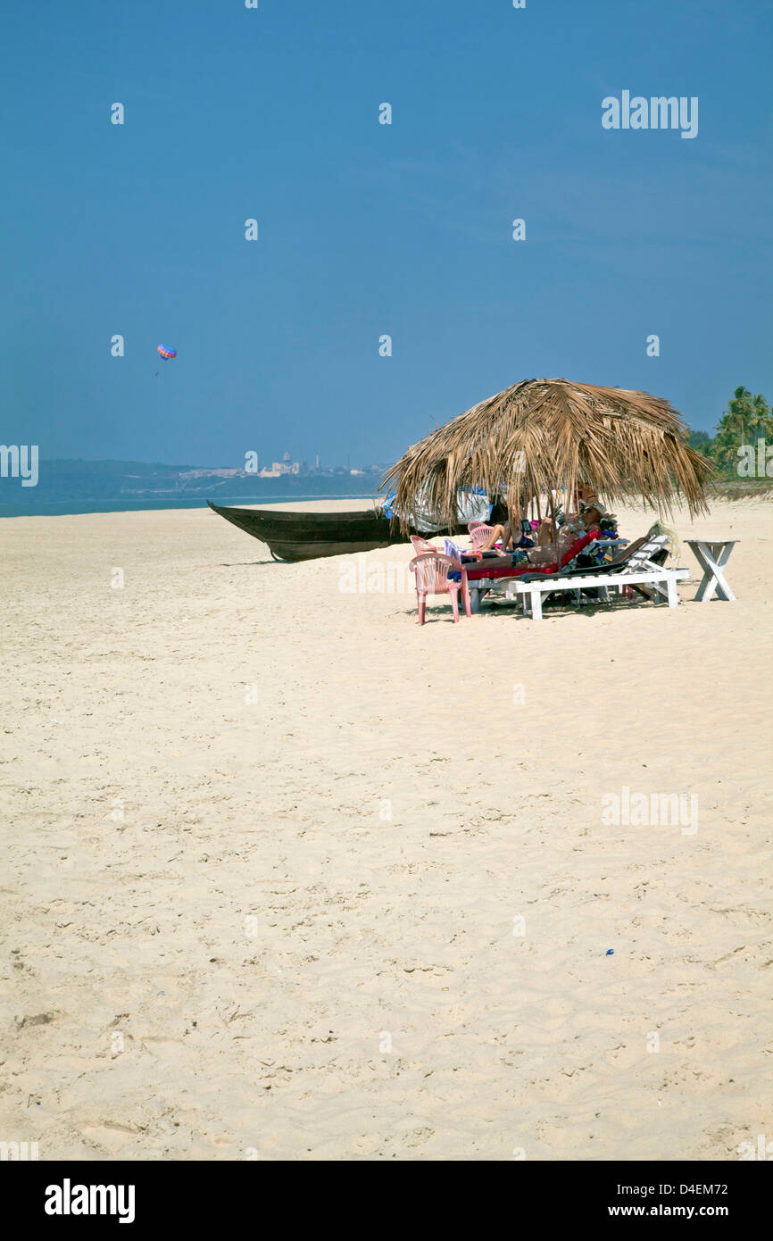 holidaymakers relaxing on secluded tropical beach under shack para ...