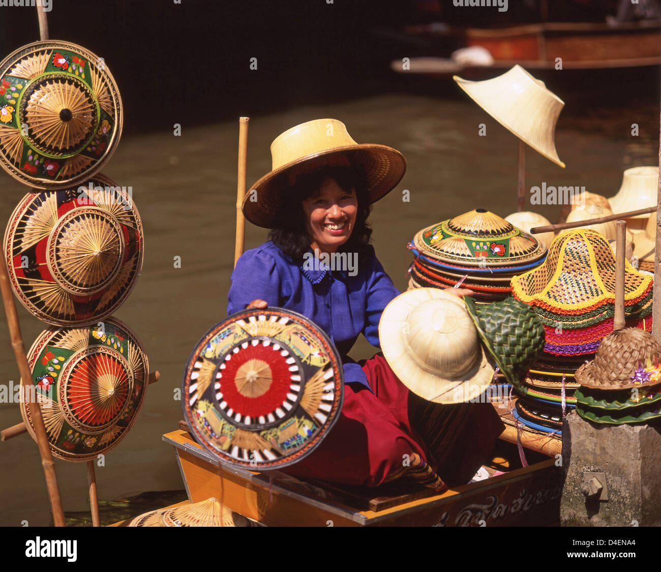 Straw hat vendor at Damnoen Saduak Floating Market, Damnoen Saduak ...