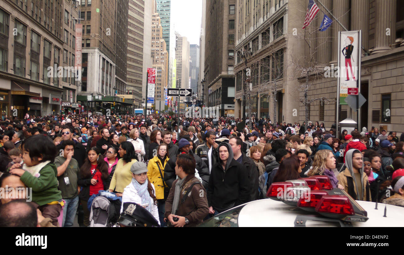 A Large Crowd of People flood the streets of Manhattan, New York. The ...