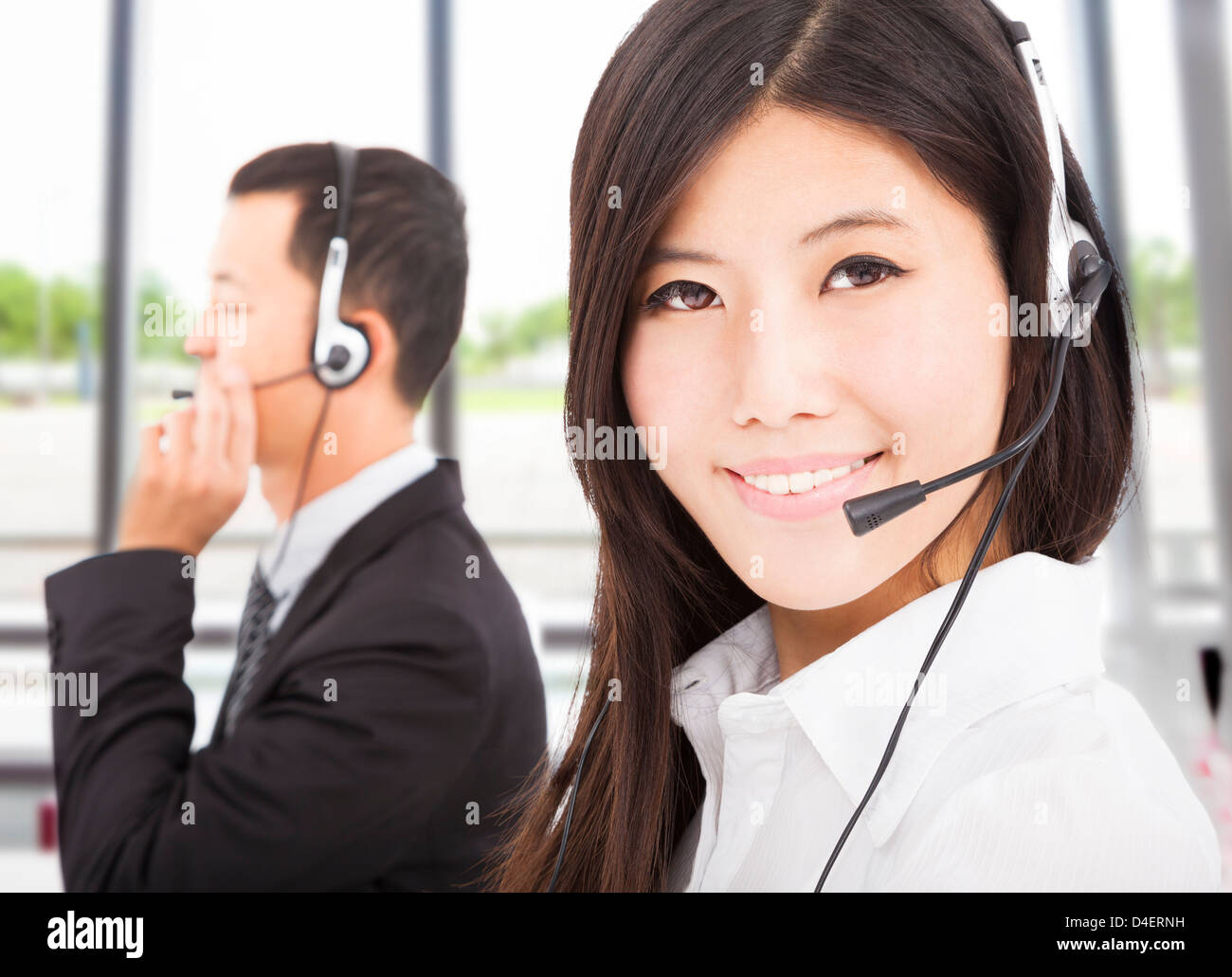 beautiful smiling businessman with call center agent Stock Photo - Alamy