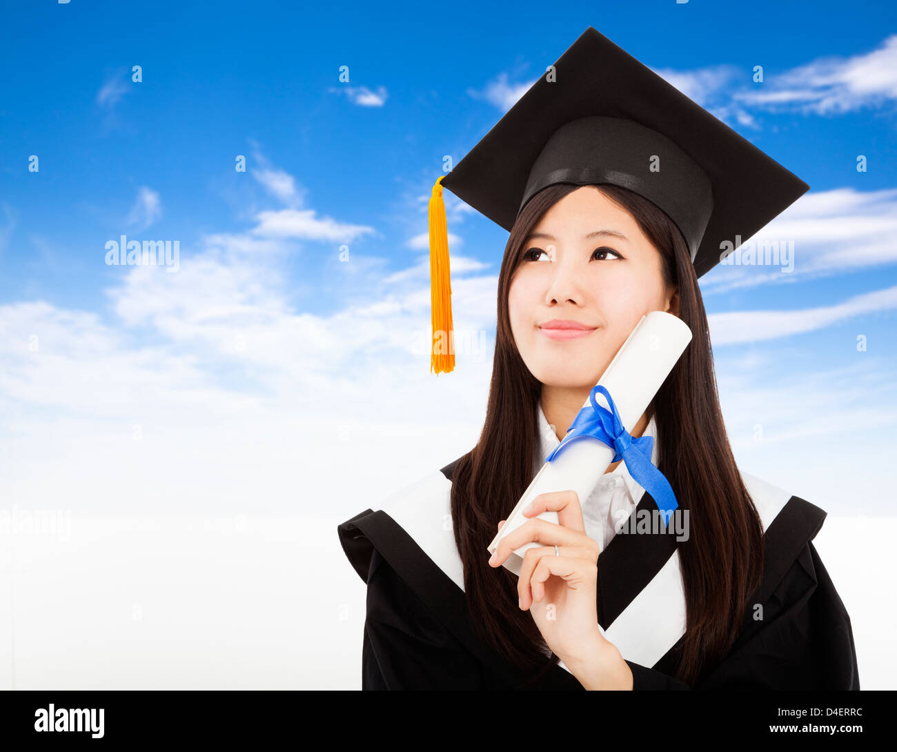 smiling Graduate woman Holding Degree with cloud background Stock Photo ...