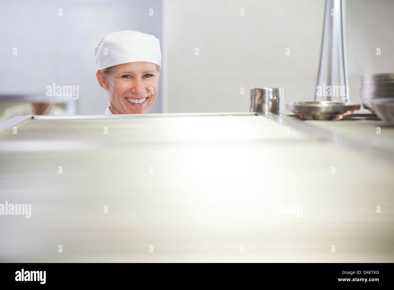 Chef smiling in restaurant kitchen Stock Photo - Alamy