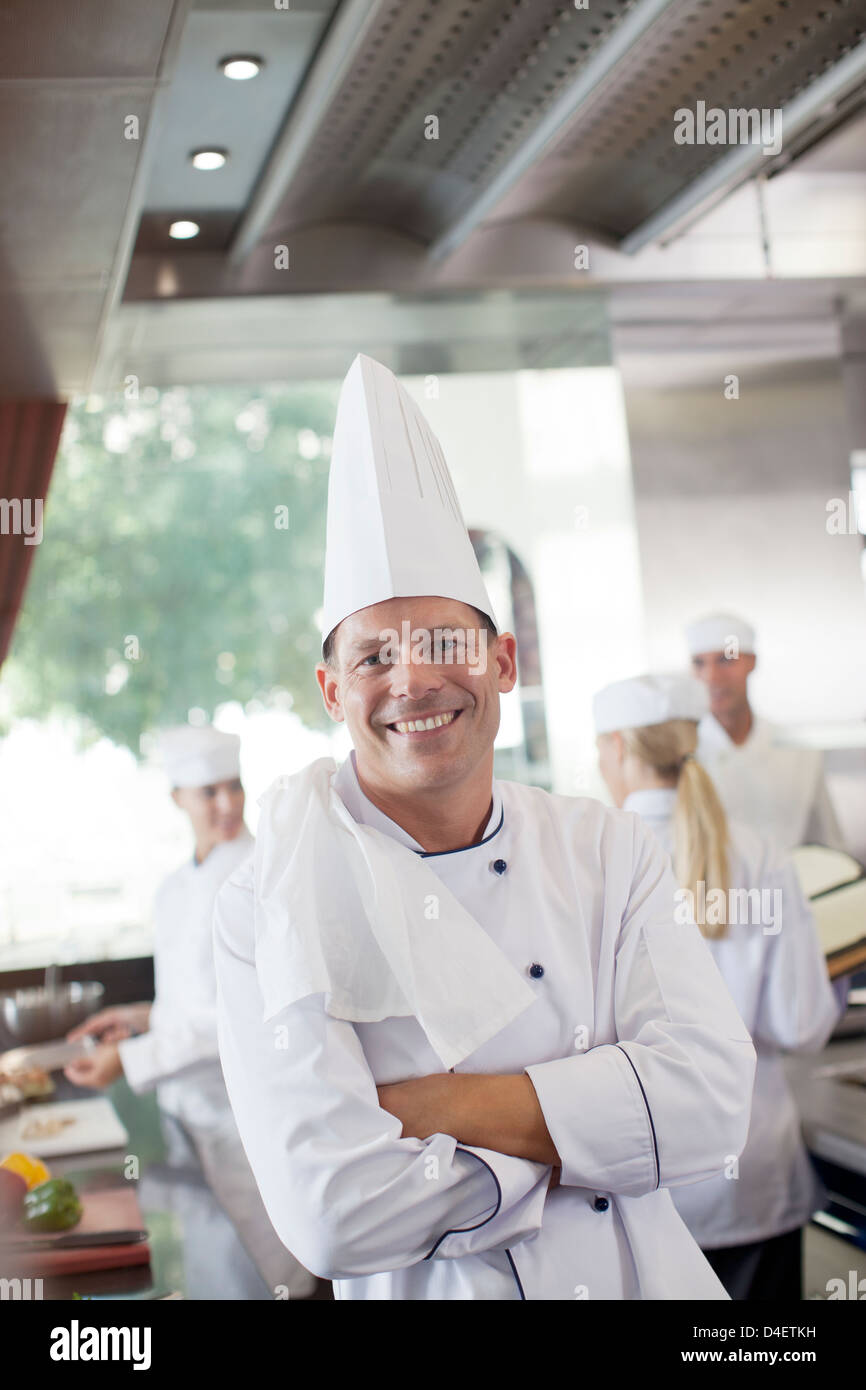 Chef smiling in restaurant kitchen Stock Photo - Alamy