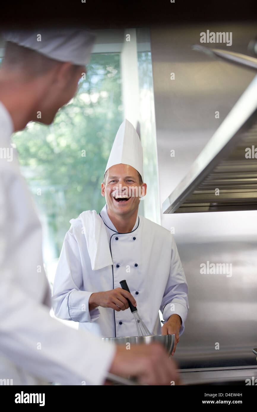 Chefs talking in restaurant kitchen Stock Photo - Alamy