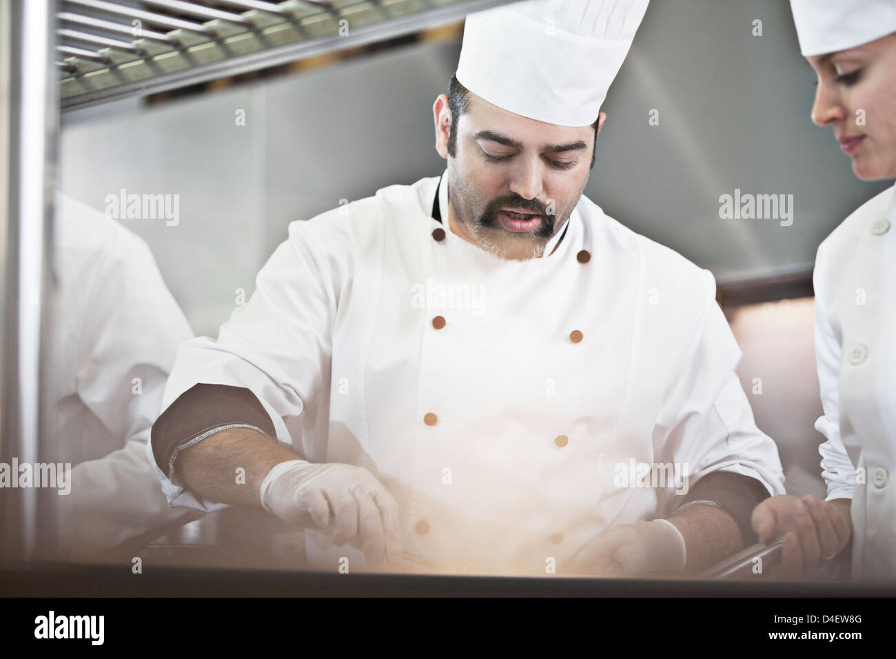 Chefs cooking in restaurant kitchen Stock Photo - Alamy