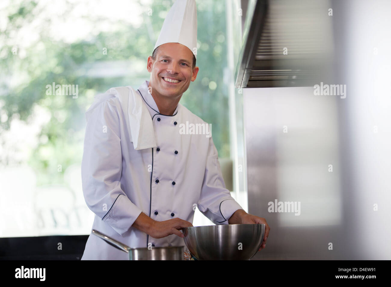 Chef smiling in restaurant kitchen Stock Photo - Alamy