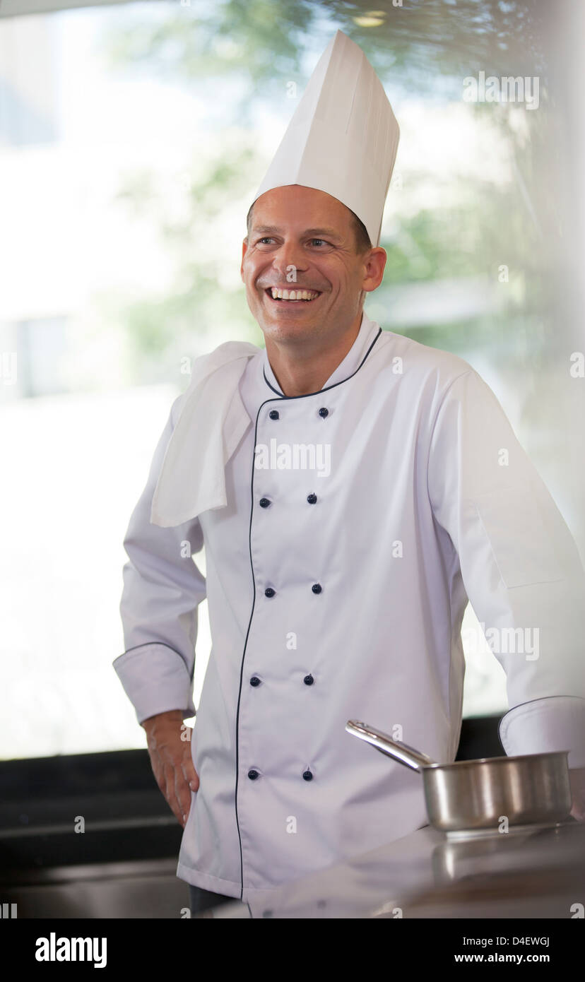 Chef smiling in restaurant kitchen Stock Photo - Alamy