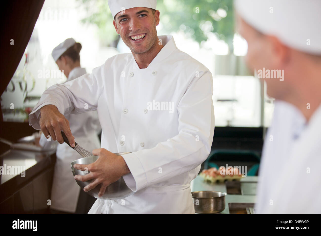 Chefs cooking in restaurant kitchen Stock Photo - Alamy