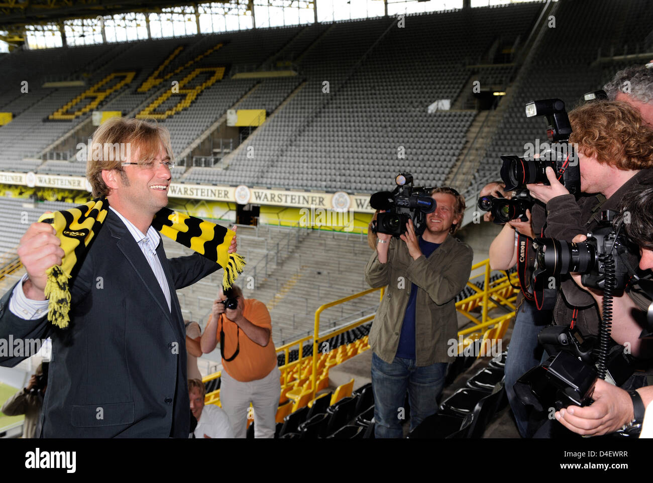 Borussia Dortmund's new coach Juergen Klopp poses with a black and ...