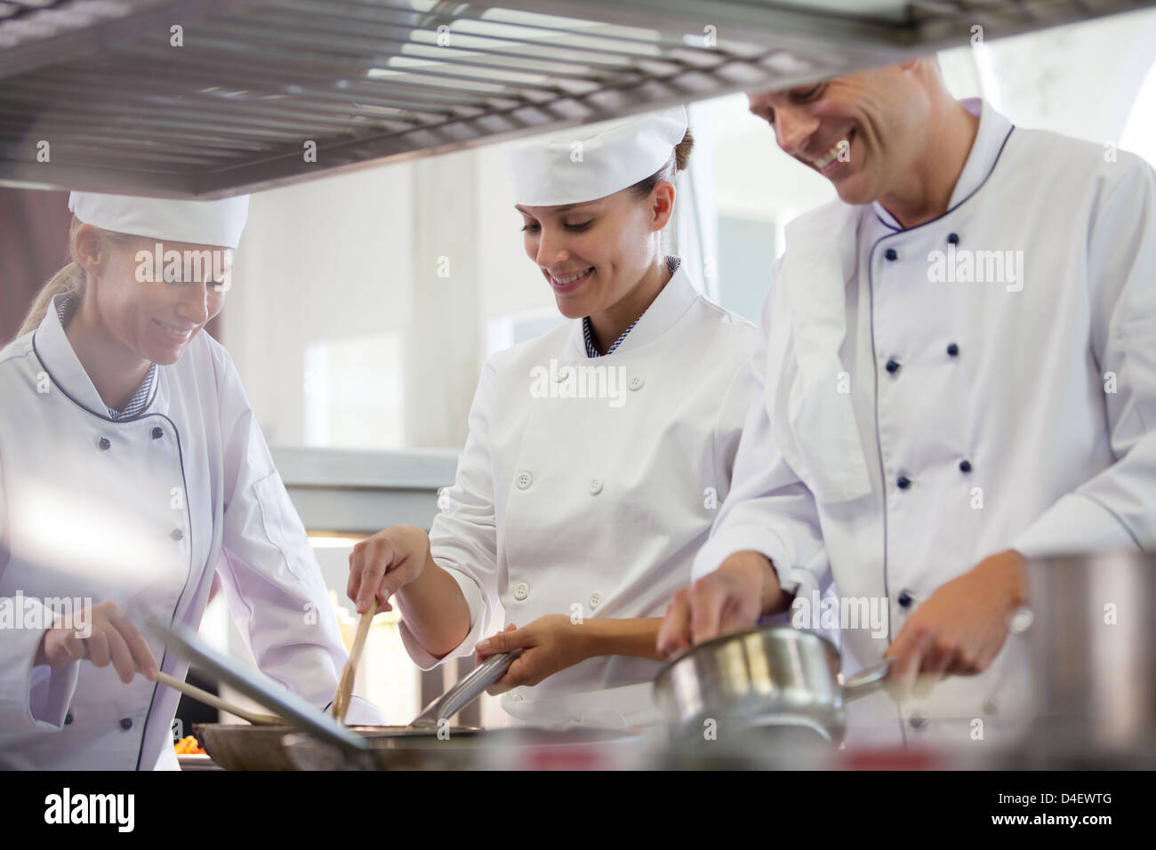 Chefs cooking in restaurant kitchen Stock Photo - Alamy