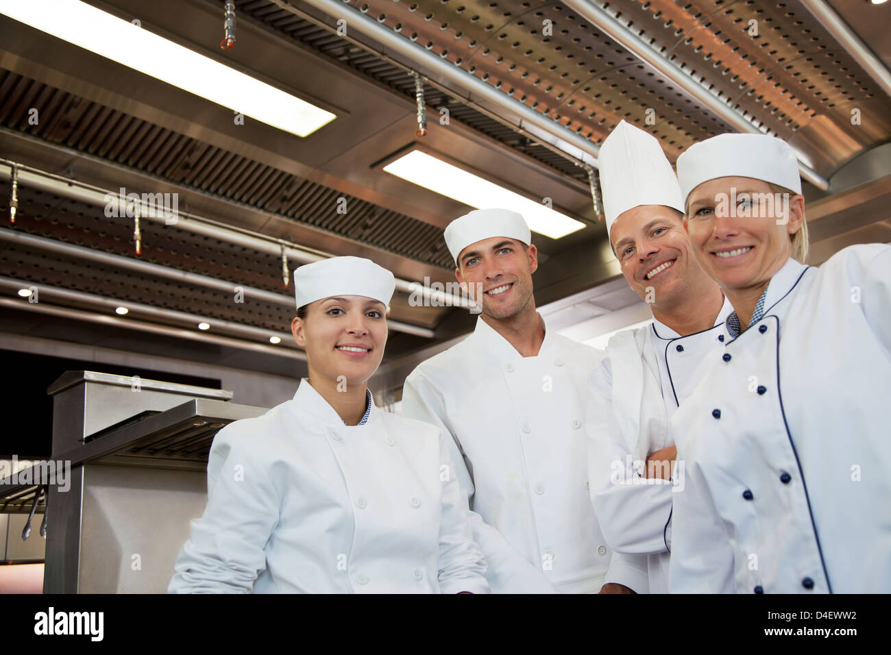 Chefs smiling in restaurant kitchen Stock Photo - Alamy