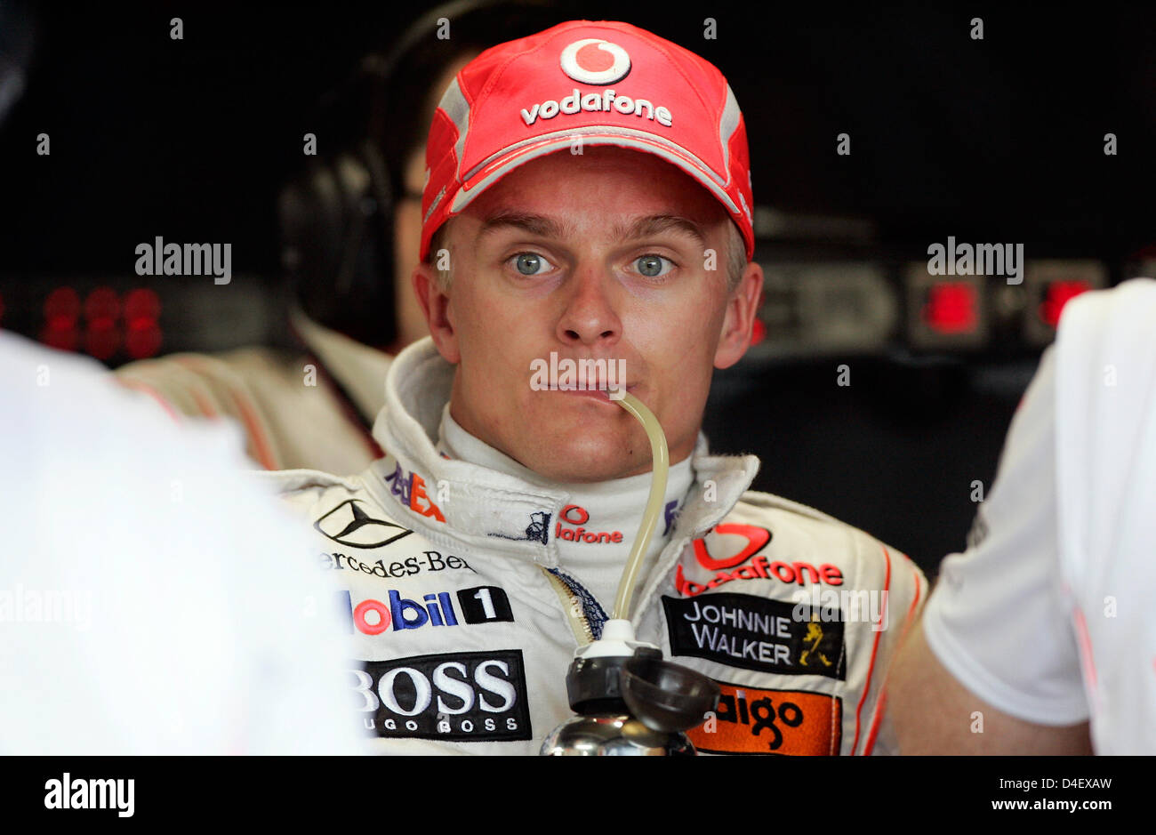 Finnish Formula One driver Heikki Kovalainen of McLaren Mercedes drinks ...