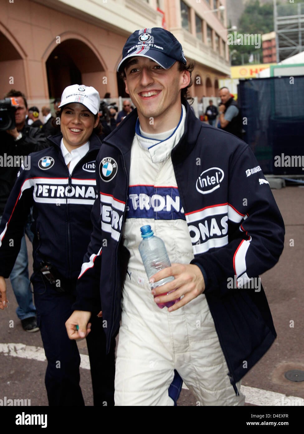 Polish Formula One driver Robert Kubica of BMW Sauber (R) walks through ...