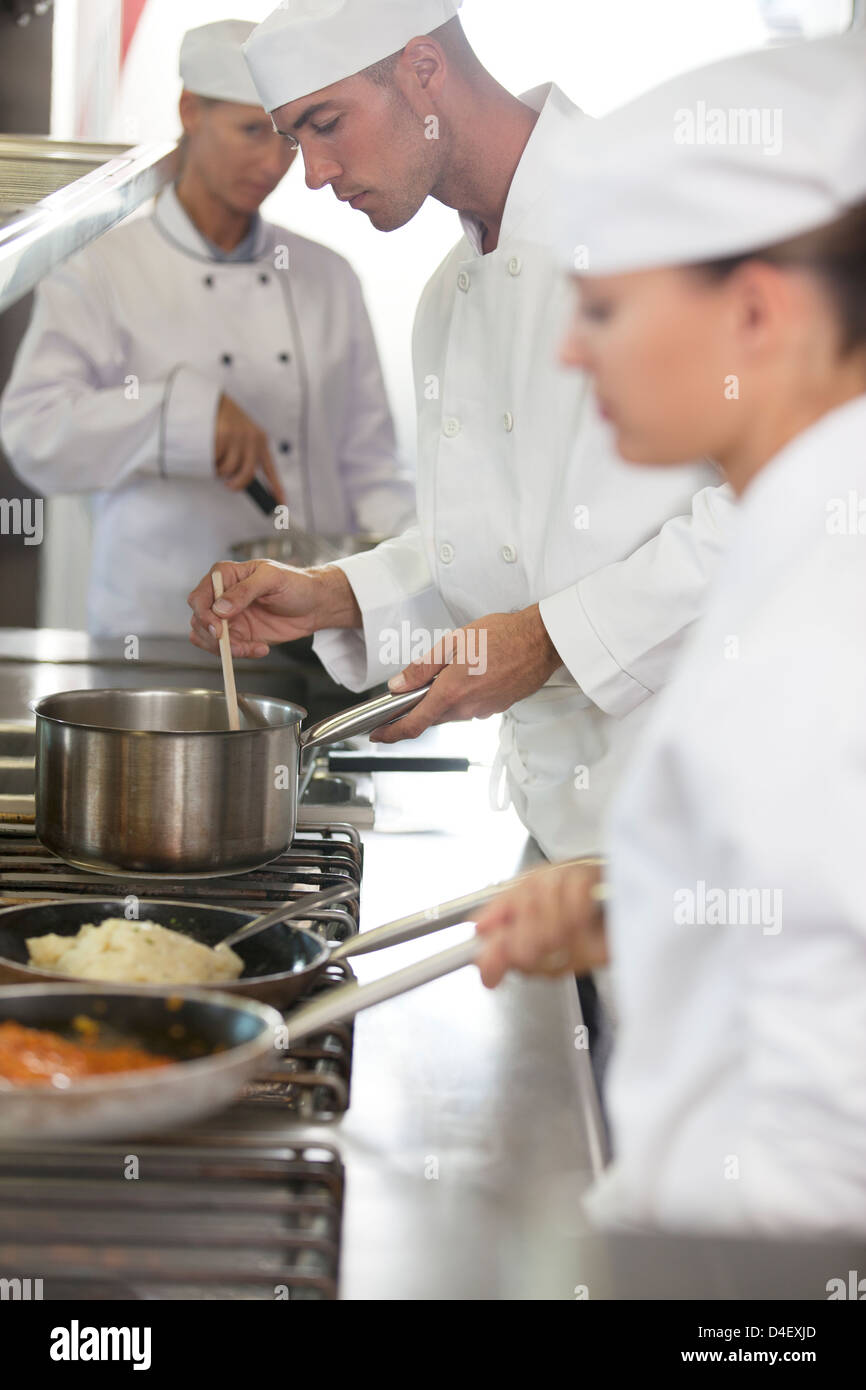 Chefs cooking in restaurant kitchen Stock Photo - Alamy