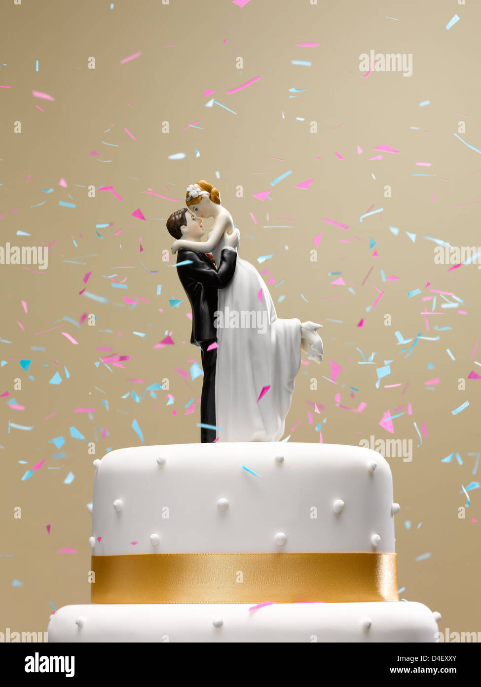 Confetti falling on wedding cake Stock Photo - Alamy