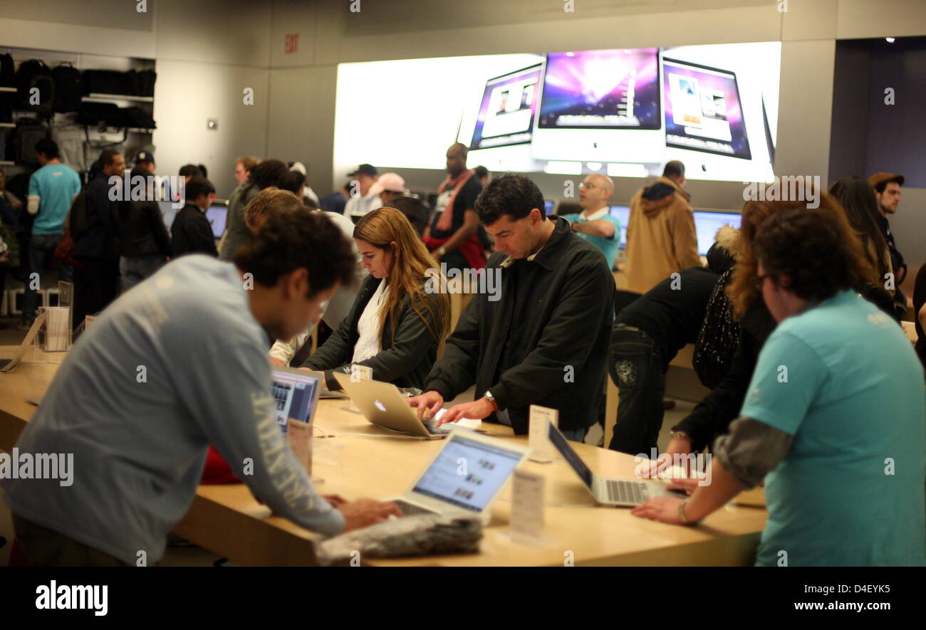 Customers check out Apple stuff in the Apple Store open 24-7 on 5th ...