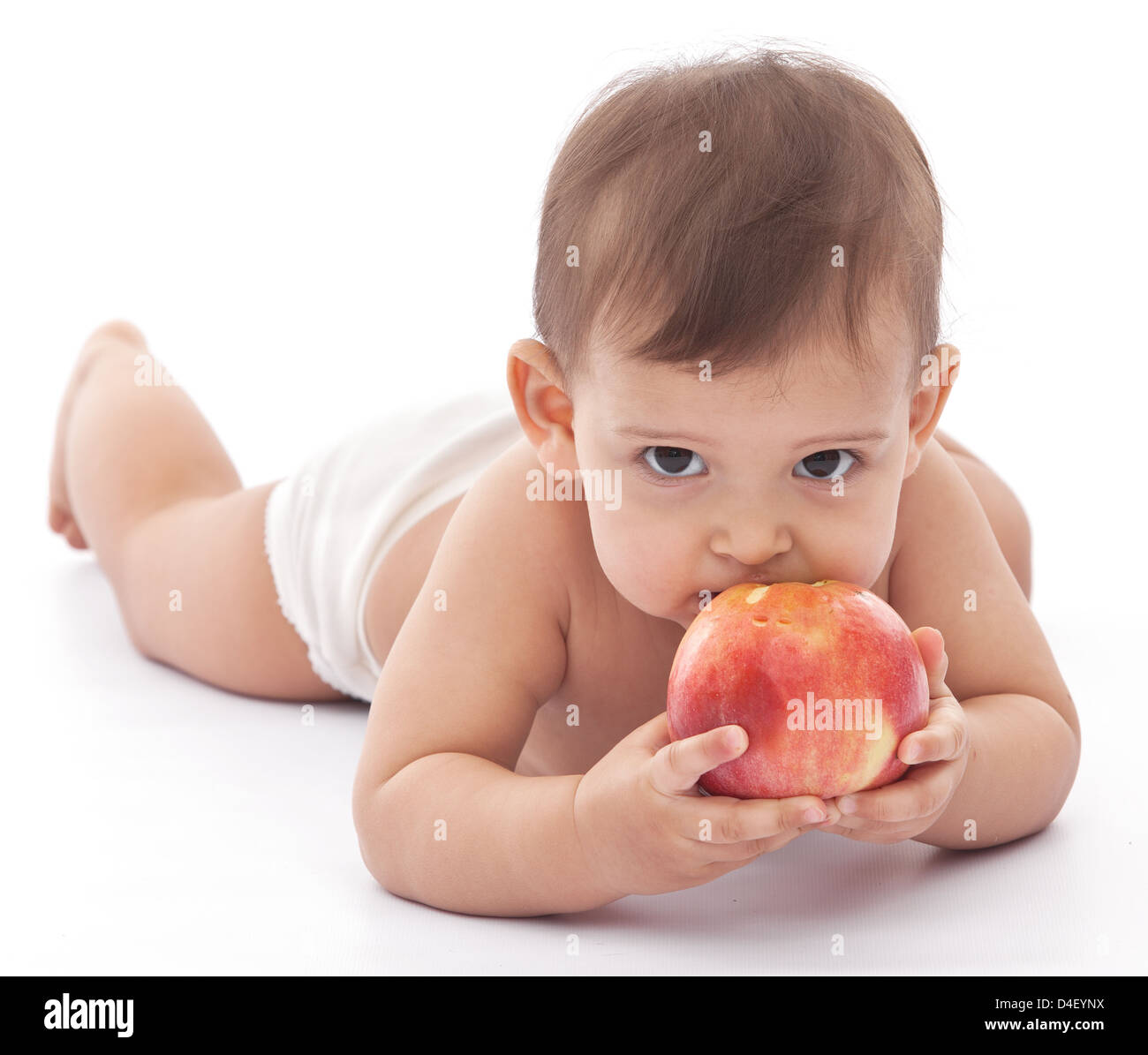 Baby girl attacking an apple. Isolated on a white background Stock ...