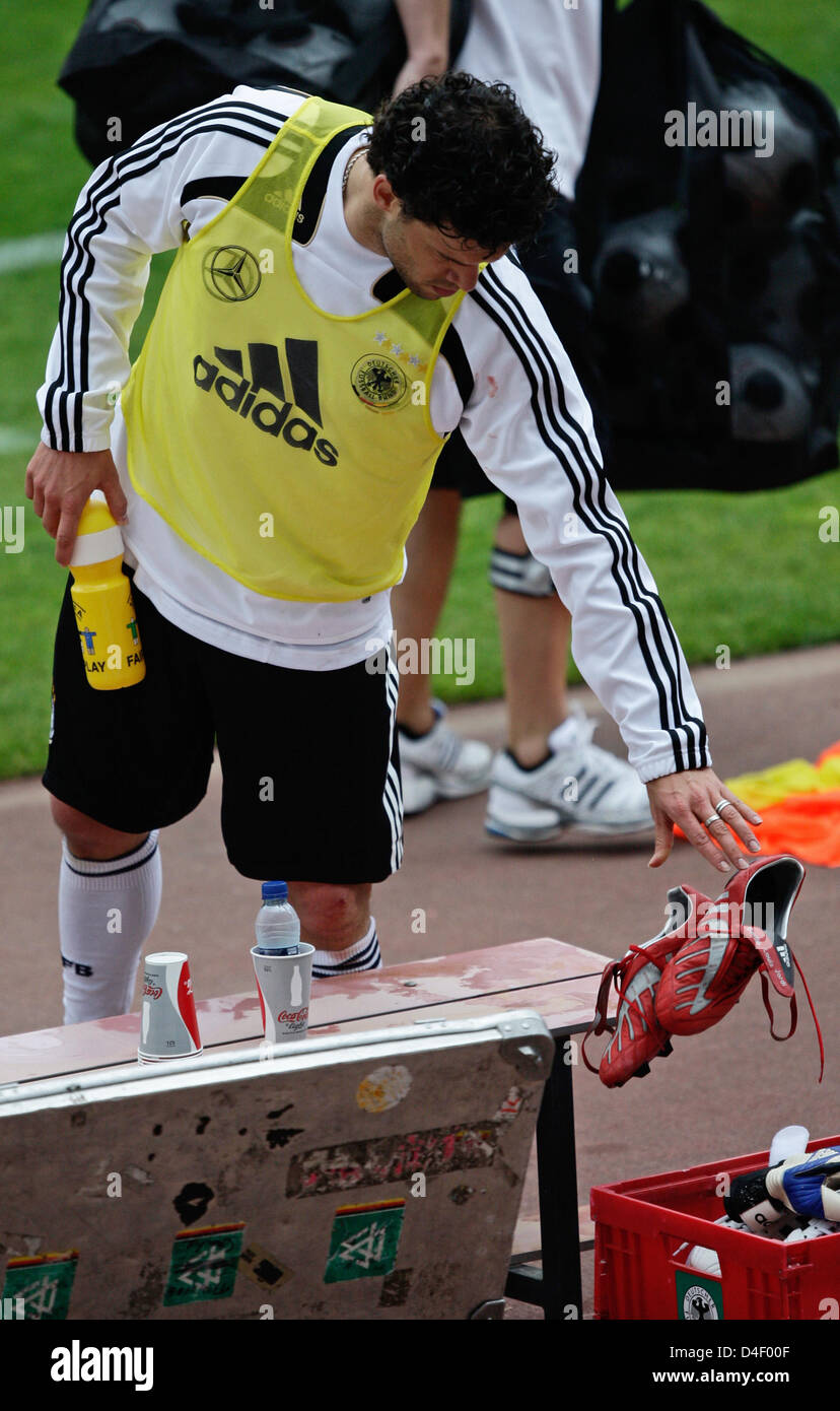 German national player Michael Ballack throws a pair of football boots ...