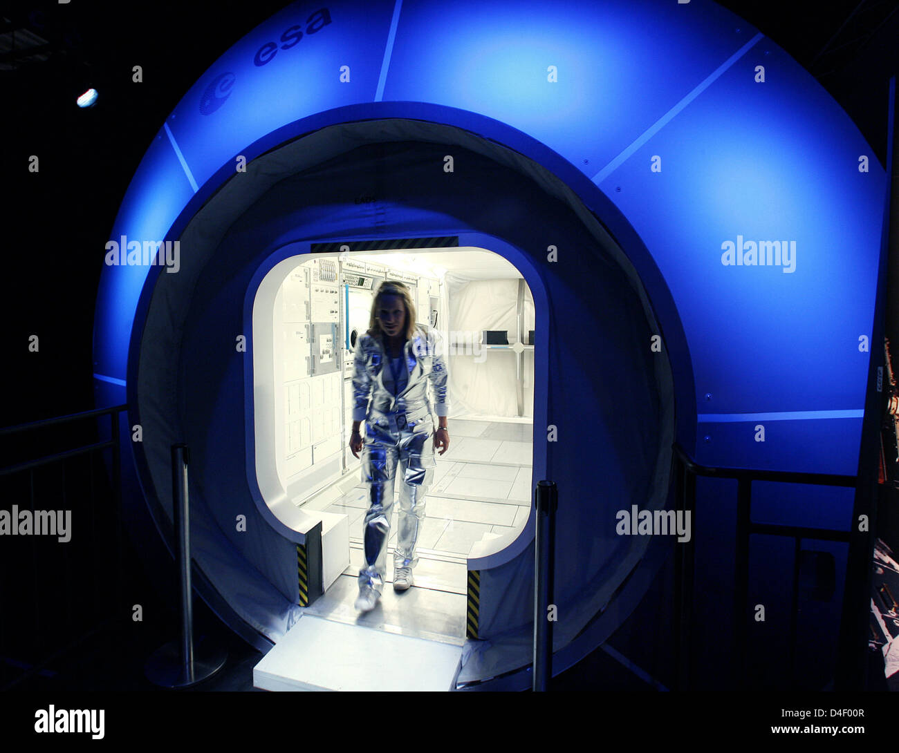 A hostess leaves a full size model of space laboratory 'Columbus ...